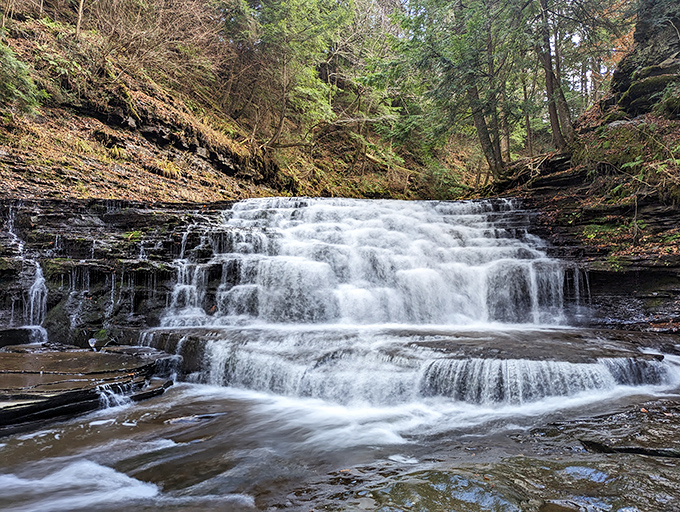 Nature's perfect waterfall tableau &ndash; where rushing water meets ancient rock in a dance that's been performing for millennia without ever taking a bow.