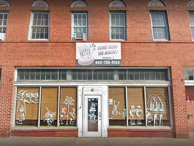 The brick facade of Mad Hatter Cafe beckons with whimsical window art and a turquoise awning&mdash;Lewis Carroll's fantasy brought to life on Salisbury's Main Street.