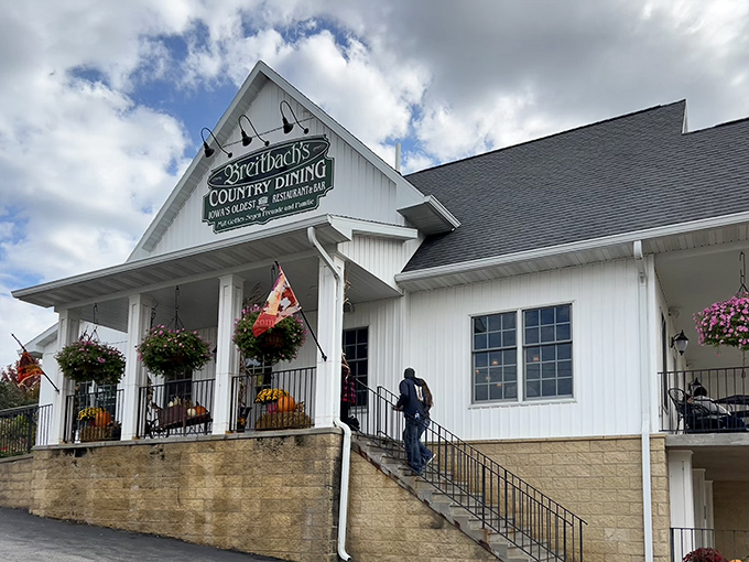 The white clapboard facade of Breitbach's stands like a beacon of comfort food, hanging flower baskets swaying in the Iowa breeze.