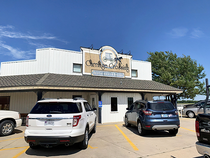 The iconic Amish carriage sits like a time machine outside Carriage Crossing, promising a journey back to when food was honest and portions heroic.