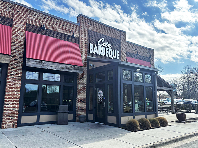 The brick fortress of flavor stands proud with its metal roof and welcoming red umbrellas&mdash;a barbecue beacon calling hungry travelers home.