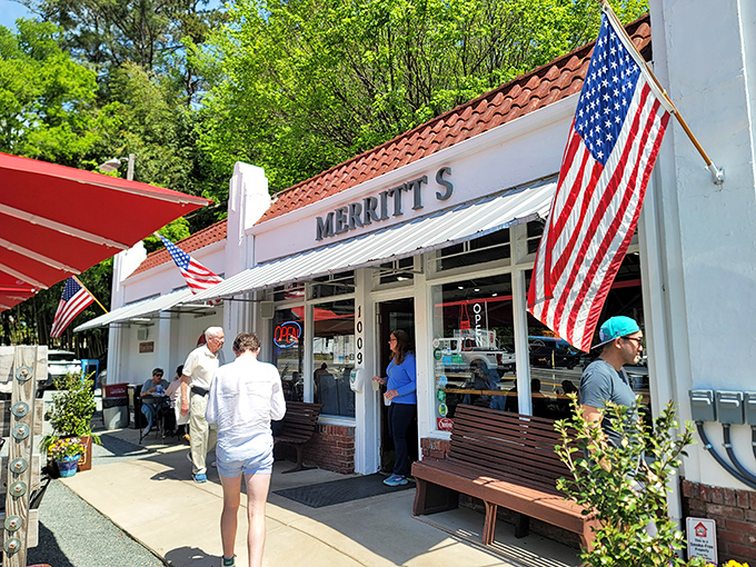 The unassuming white building with American flags proudly waving says it all: great food doesn't need fancy architecture, just perfect execution.