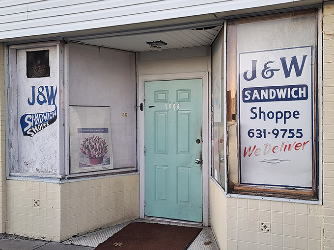 The blue door to sandwich paradise doesn't need neon signs or fancy awnings&mdash;just the promise of "We Deliver" and decades of deliciousness.