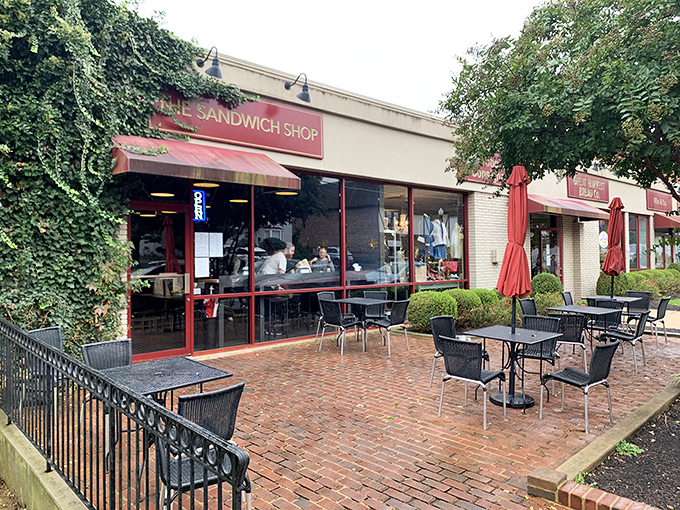 The red-framed storefront of The Sandwich Shop beckons like a beacon of lunch salvation, complete with charming brick patio seating under Vienna's leafy canopy.