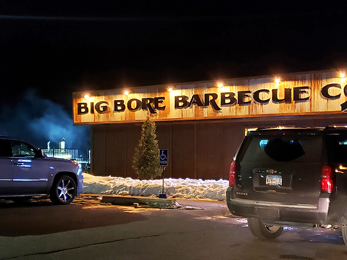 The weathered corrugated metal exterior of Big Bore Barbecue stands as a rustic beacon for meat lovers—industrial chic meets smokehouse authenticity.
