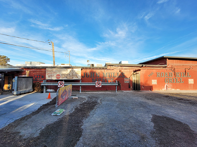 The bright red exterior of Road Kill Grill stands like a barbecue beacon in North Las Vegas, promising smoky delights within those unassuming walls.