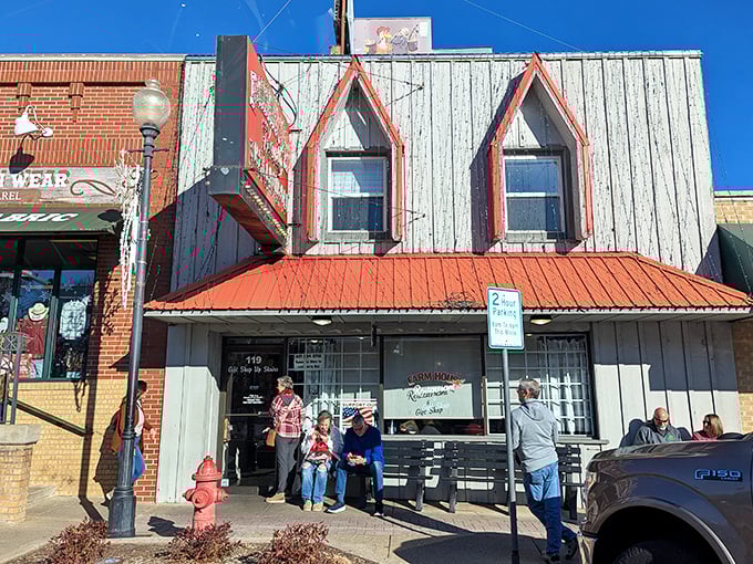The weathered wood siding and red-trimmed windows aren't trying to impress anyone, yet the line of hungry patrons tells you everything you need to know.