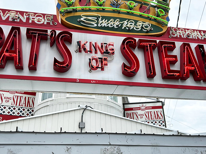 The brick-and-mortar kingdom where cheesesteak dreams come true since 1930. Pat's iconic red and white facade has witnessed nine decades of sandwich perfection.