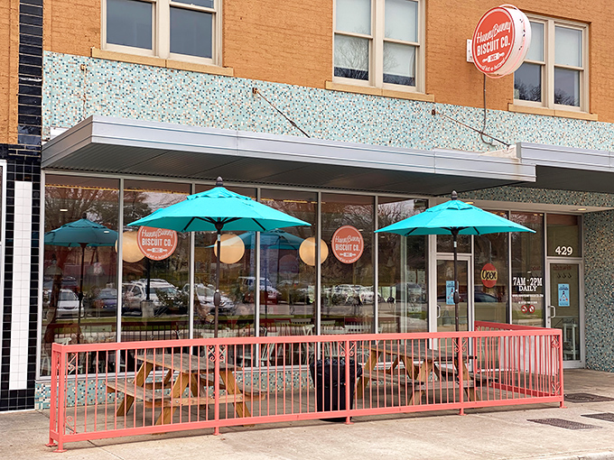 The coral-railed patio at HunnyBunny beckons like a breakfast siren song, with the iconic Tower Theater sign standing guard nearby.