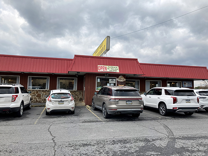 The iconic red roof and stone facade of Sunset West Restaurant stands as a beacon of comfort food in Pleasant Gap, where hungry travelers find their breakfast destiny.