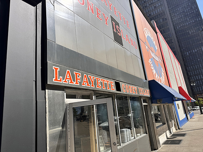 The iconic Lafayette Coney Island fa&ccedil;ade glows like a beacon for hungry night owls, promising Detroit's most famous comfort food against the city skyline.