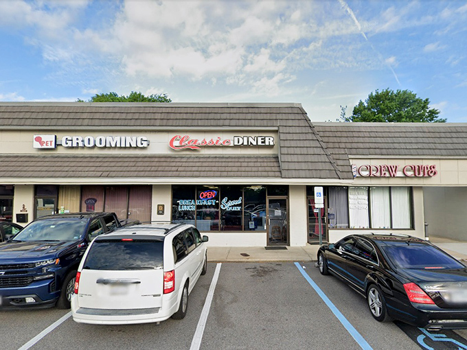 The shingled exterior of Classic Diner beckons with its bold red script and neon promise of daily breakfast. Some buildings just look like they know how to feed you right.