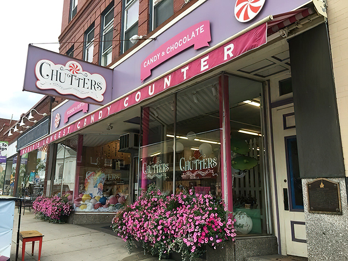 The iconic pink storefront of Chutters beckons like a sugary mirage on Littleton's Main Street. Those purple flowers aren't just decoration&mdash;they're a warning sign that willpower goes to die here.
