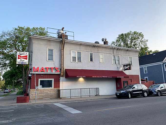 The unassuming exterior of Matt's Bar stands like a humble temple to burger perfection, its red and white facade hiding culinary treasures within.