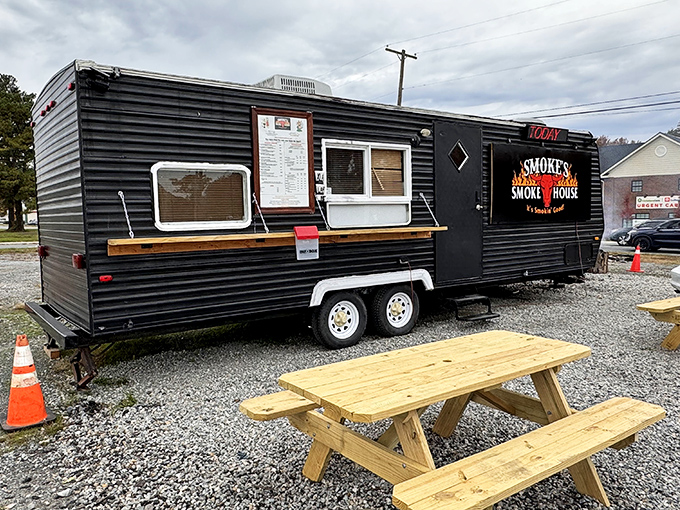 The black trailer with flames on the logo isn't just a food truck—it's a smoke-signaling beacon for BBQ pilgrims across Delaware.