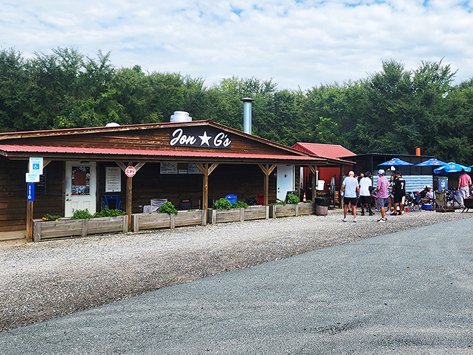 The line forms early at Jon G's rustic wooden facade, where BBQ pilgrims gather with the reverence of concert-goers awaiting a legendary headliner. 