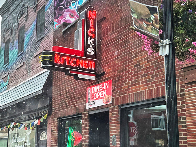 The iconic neon sign of Nick's Kitchen beckons like a lighthouse for hungry travelers in downtown Huntington. Comfort food paradise awaits!