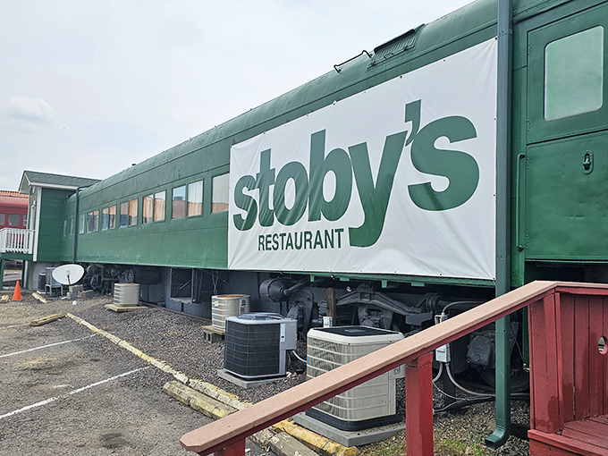 The iconic green train car of Stoby's stands proudly against an Arkansas sunset, promising culinary adventures that don't require a ticket.
