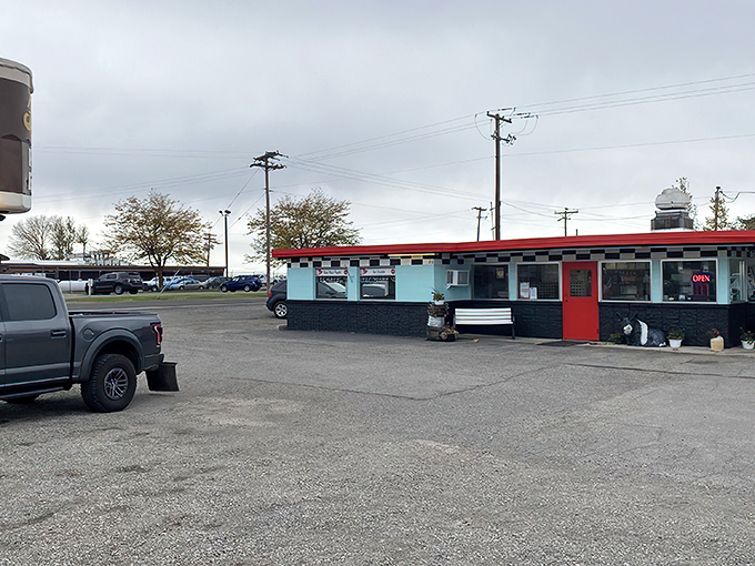 The time-capsule exterior of Frostop Drive In beckons with its vintage signage and welcoming bench&mdash;a portal to simpler, more delicious times.