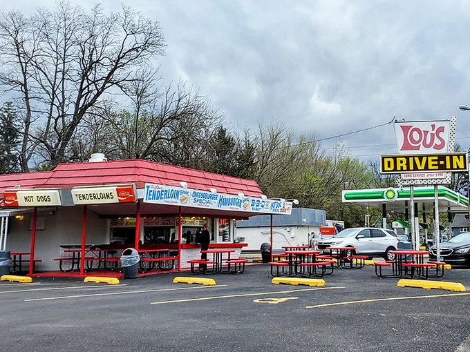 Lou's iconic red-roofed stand beckons like a neon-lit time machine, promising tenderloins and nostalgia in equal measure.