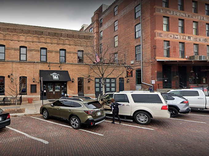 The historic brick facade of Upstream Brewing Company stands proudly in Omaha's Old Market, its former firehouse identity preserved with architectural integrity and charm.