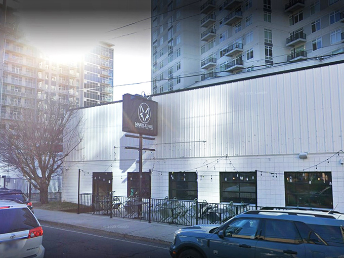 The unassuming white exterior of Marble Fox Brewing Company stands like a blank canvas, hiding the flavor explosion waiting inside. Nashville's best-kept liquid secret.