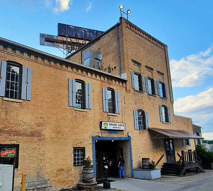Stone Arch Brewpub's historic brick exterior with blue shutters stands as Appleton's answer to "where should we eat tonight?" Timeless charm meets modern craft brewing.
