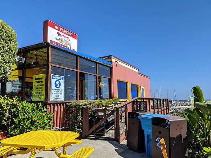 The iconic orange-red exterior of Barbara's Fishtrap stands like a delicious mirage against the Half Moon Bay coastline, complete with a whimsical fish sign that's practically winking at hungry passersby.
