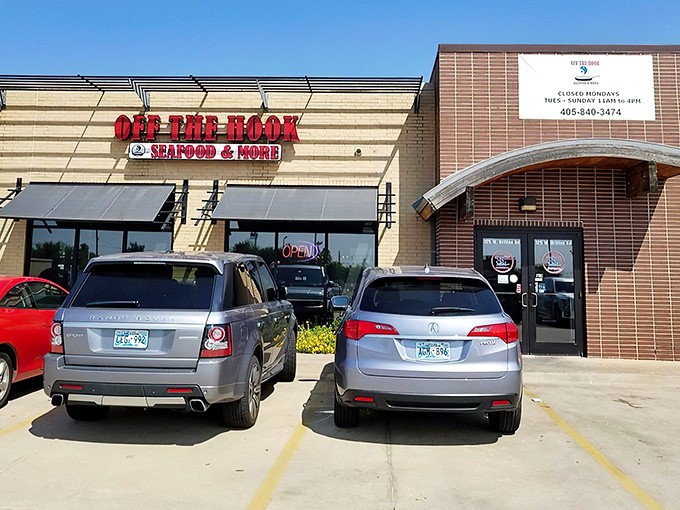 The bright red signage against tan brick promises seafood salvation in a landlocked state. Oklahoma's coastal embassy awaits.