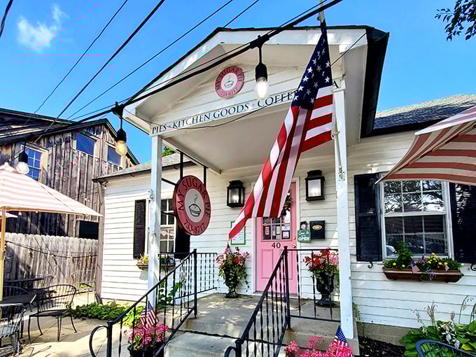The white cottage with that irresistible pink door isn't just inviting—it's practically daring you to come inside and indulge.