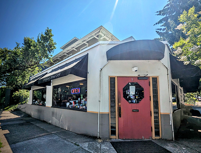 The unassuming storefront of Stepping Stone Caf&eacute;, with its simple black awning and neon "OPEN" sign, promises zero pretension and maximum flavor.
