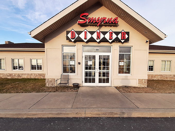 The iconic Smyrna Diner welcomes hungry travelers with its distinctive diamond-patterned sign and cozy stone facade. Delaware comfort food headquarters since the 1950s.
