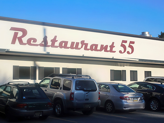 The classic red script signage welcomes you like an old friend. That vintage Mercedes in the parking lot suggests you're not the only one with good taste.