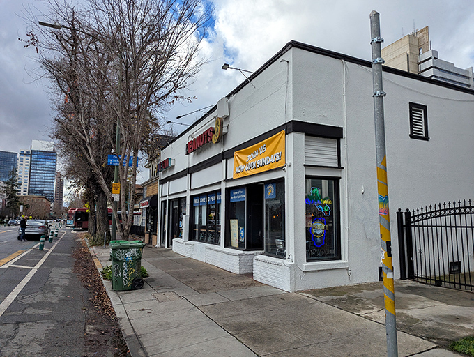 The unassuming white exterior of Peanuts Deluxe Cafe stands like a culinary lighthouse in San Jose, beckoning hungry locals with its bright red signage.