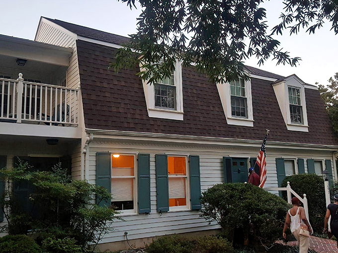 The Miller-Dunham House stands like a Norman Rockwell painting come to life, complete with sunlight filtering through mature trees and a welcoming brick patio.