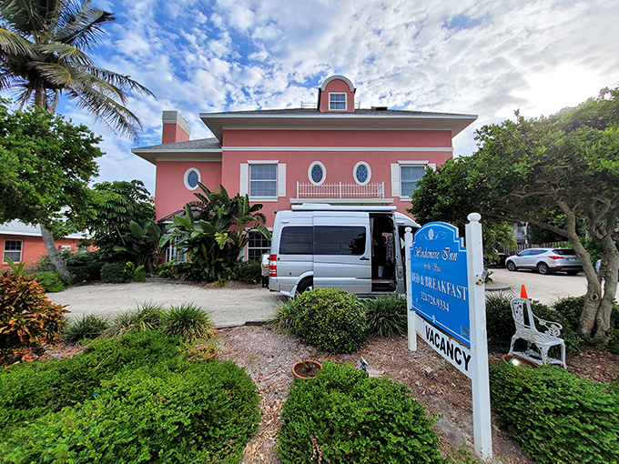 The coral-pink fa&ccedil;ade of Windermere Inn by the Sea stands like a blushing debutante against Florida's blue sky, promising coastal comfort with every white-trimmed window.