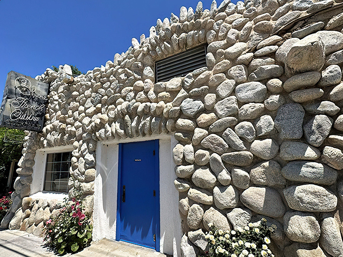 Stone by stone, this fairy tale fa&ccedil;ade promises culinary magic within. The blue door isn't just an entrance&mdash;it's a portal to France itself.