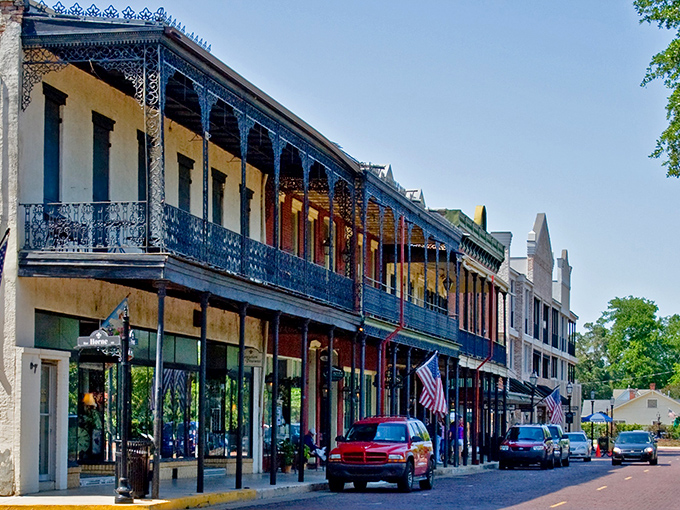 Front Street's historic charm on full display, where brick-paved streets and wrought-iron balconies create Louisiana's most walkable small-town downtown. 