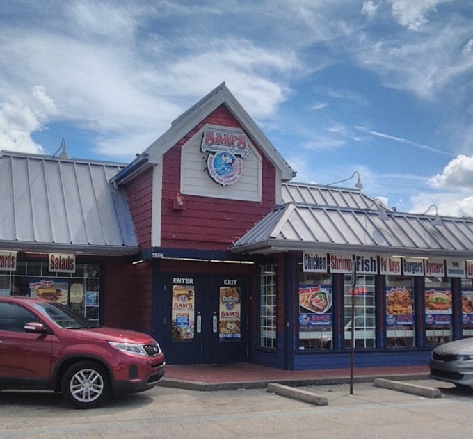 The bright red exterior of Sam's Southern Eatery stands out like a culinary lighthouse, beckoning hungry travelers with promises of comfort food treasures within.