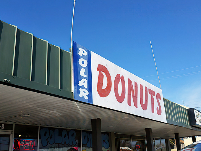 The blue and red signage beckons like a sugar-coated lighthouse. Polar Donuts' storefront promises sweet adventures within those frosty-themed walls.