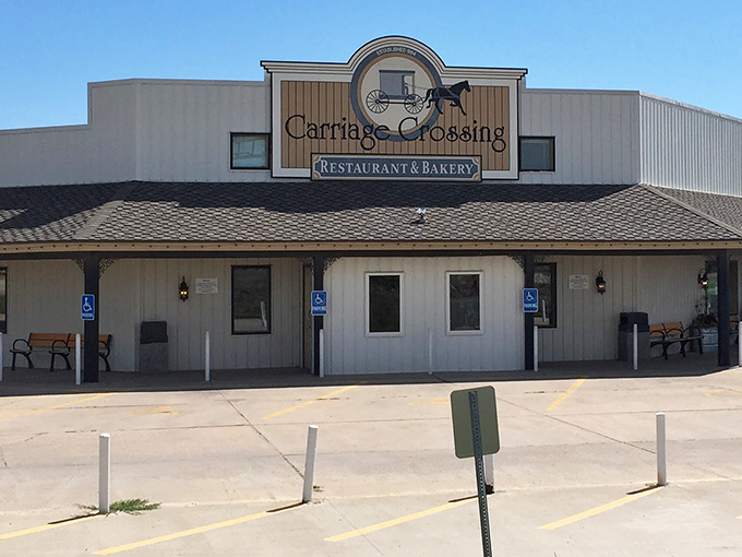 The unassuming white exterior of Carriage Crossing stands like a beacon of hope for hungry travelers. Kansas sunshine optional, cinnamon rolls guaranteed.