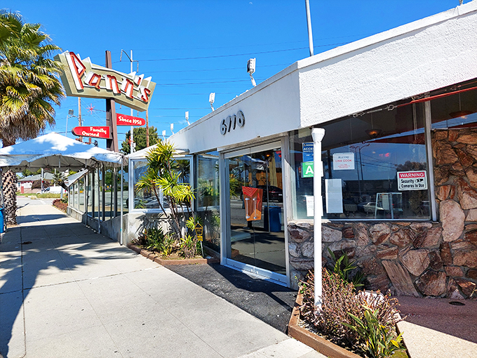 That iconic angular roof isn't just showing off&mdash;it's practically waving you in from the highway, promising comfort food beneath its Googie glory.