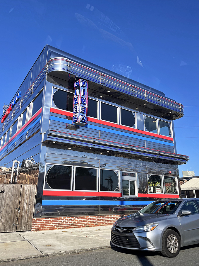 The gleaming chrome exterior of Goobers Diner stands like a time machine to the 1950s, complete with those iconic red and blue stripes that practically scream "great breakfast inside!"