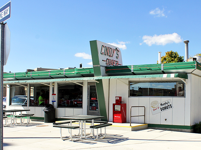 The classic green and white exterior of Cindy's Diner stands proudly in downtown Fort Wayne, promising breakfast magic with its vintage charm.