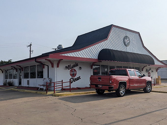 The red and white exterior of Classic Diner stands like a time capsule on Henryetta's landscape, beckoning hungry travelers with its vintage charm and glowing "OPEN" sign.