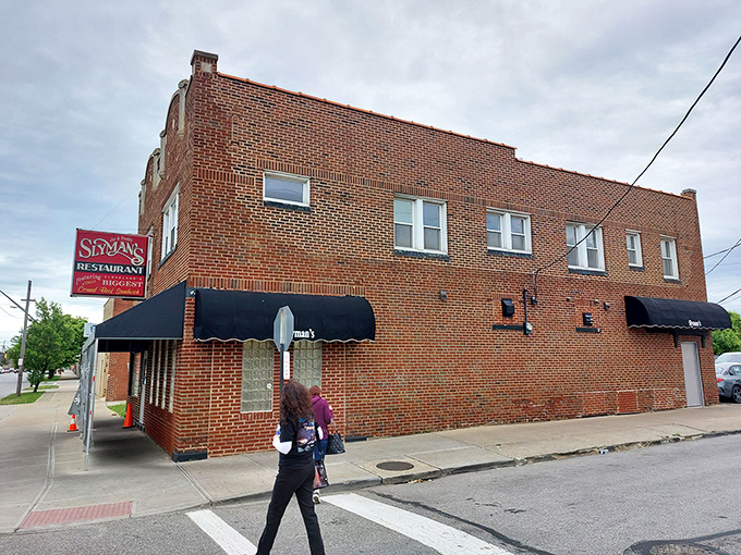 The iconic red Slyman's sign promises "Cleveland's Biggest and Best Corned Beef Sandwiches" – a bold claim they've been backing up for decades.