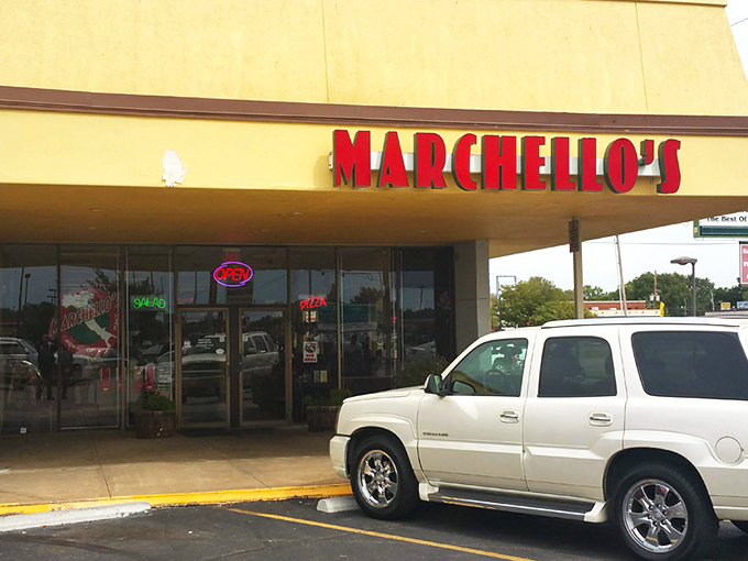 The bright red Marchello's sign stands out like a culinary lighthouse, beckoning hungry travelers to this unassuming strip mall treasure in Wichita.