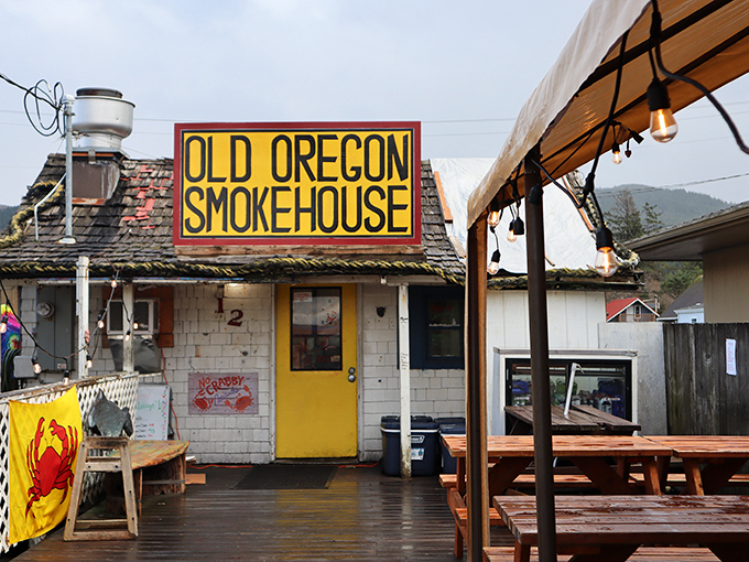 The yellow door beckons like a coastal lighthouse. This weathered shack with its bold sign promises seafood treasures that fancy restaurants can only dream about.