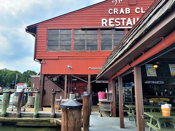 The iconic red exterior of The Crab Claw stands like a beacon for seafood lovers, perched on stilts above the water as if to say, "Come hungry, leave happy."