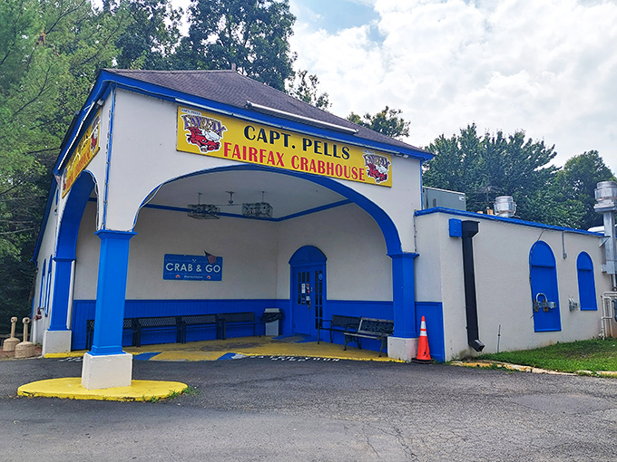 The blue and white exterior of Captain Pell's stands like a maritime beacon in suburban Fairfax, promising seafood treasures within. No pretension, just delicious anticipation.